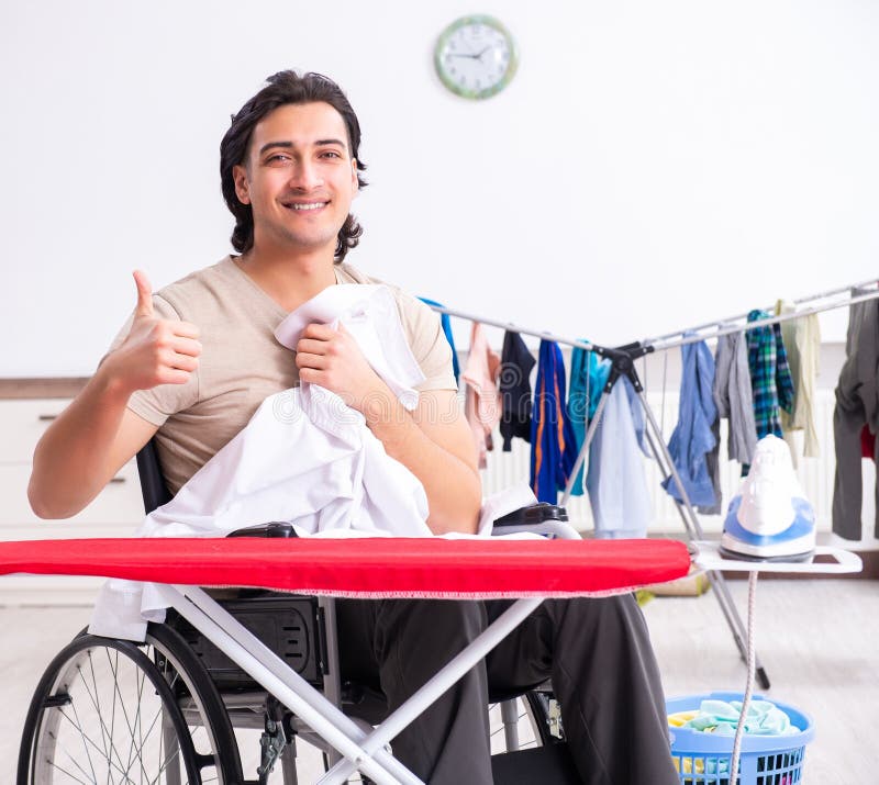 Young Man in Wheel-chair Doing Ironing at Home Stock Photo - Image of ...