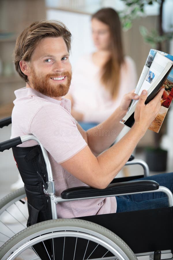 Young Man on Wheelchair Reading Book at Home Stock Image - Image of ...