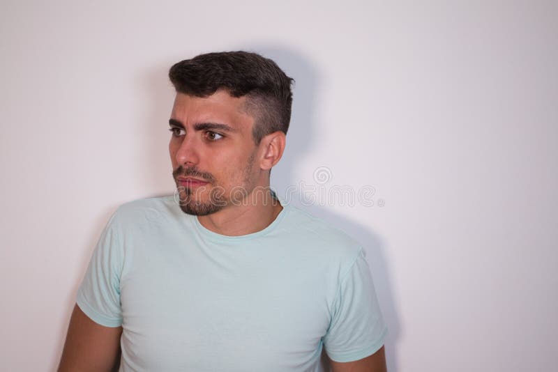 Young Man on White Background Looking in Profile and Smiling. Concept ...