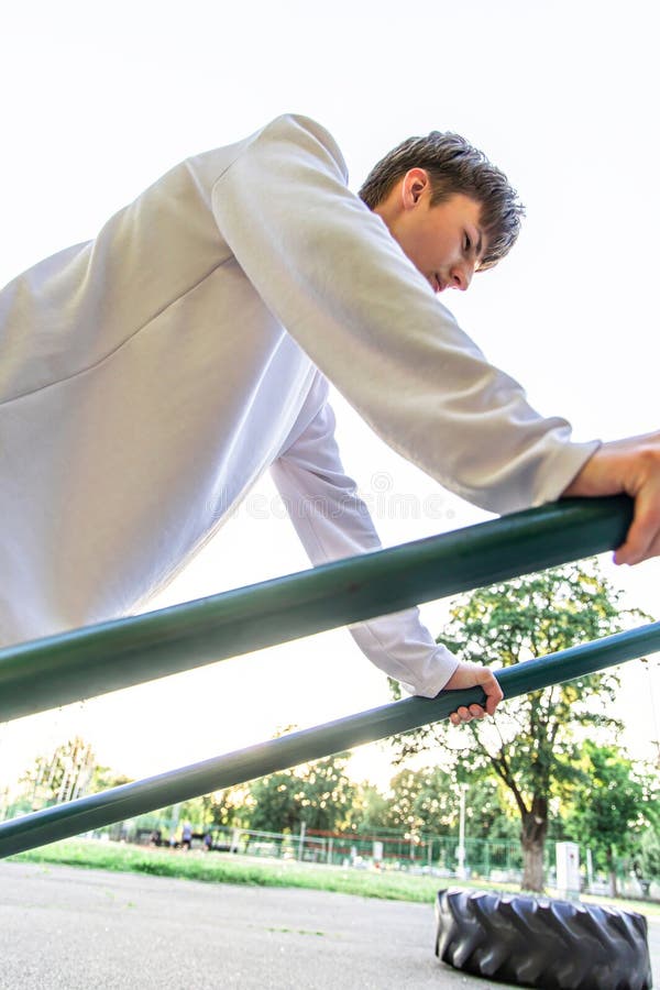 Young Man Exercising on Parallel Bars at an Outdoor Park Stock Image ...