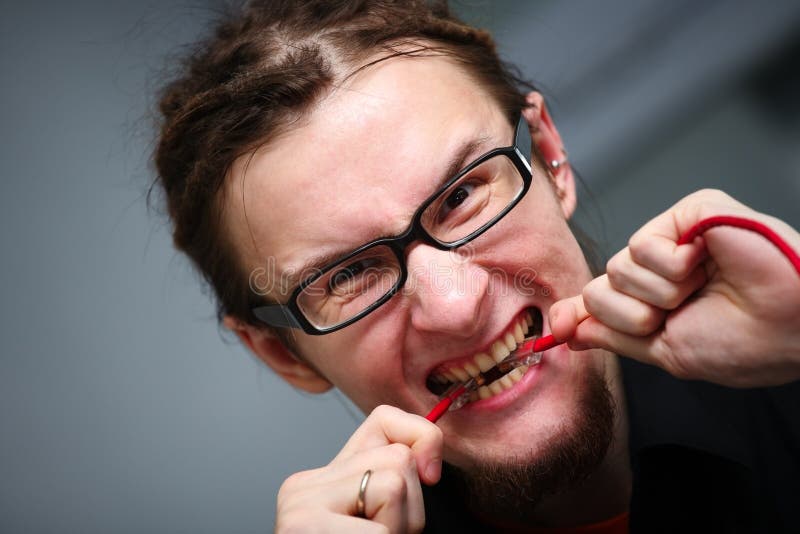 Young Man with a Wire in the Teeth Stock Photo - Image of head ...