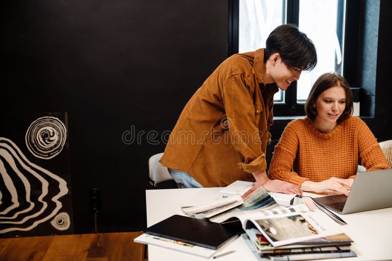 Young Man and Woman Architects Discussing Design Project and Using ...