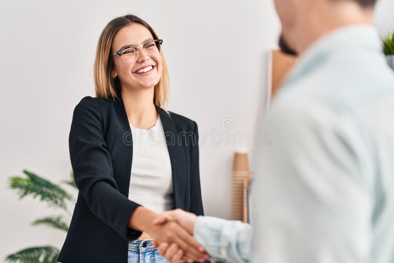 Young Man and Woman Business Workers Shake Hands Working at Office ...