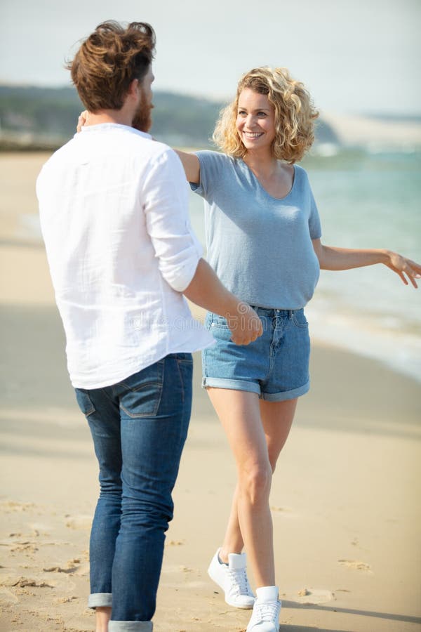 Young Man and Woman Having Fun Dancing on Beach Stock Image - Image of ...