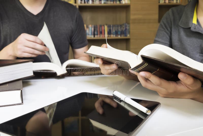Young Man and Woman Reading Book in Library Stock Image - Image of ...