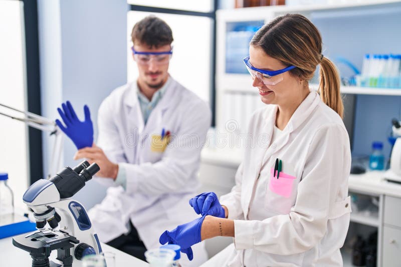 Young Man and Woman Scientists Workers Wearing Gloves at Laboratory ...