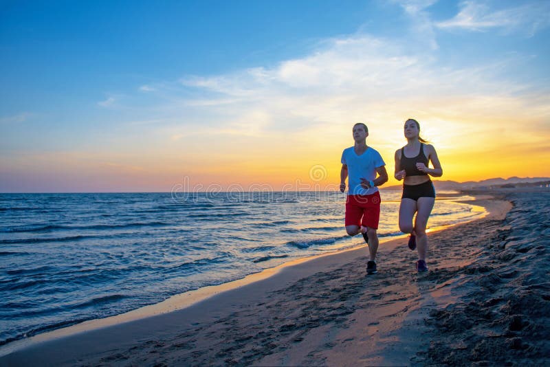 Man and Women Running on Tropical Beach at Sunset Stock Image - Image ...