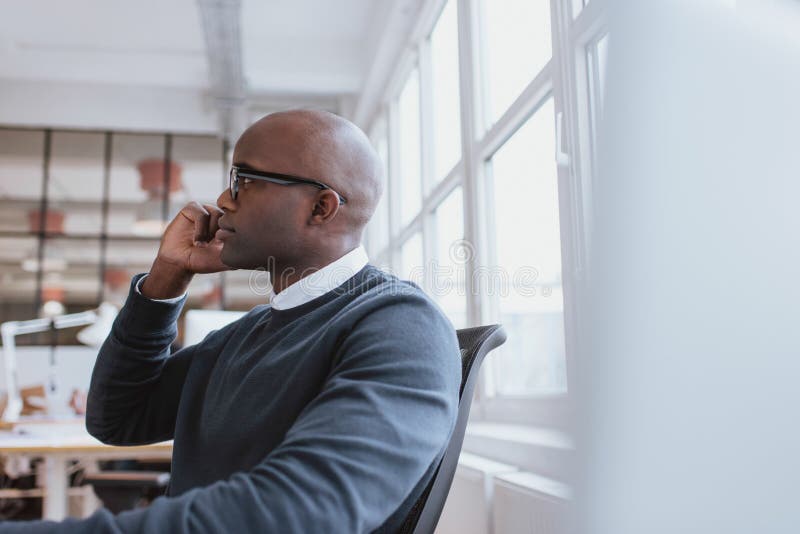 Young Man at Work Answering a Phone Call Stock Photo - Image of descent ...