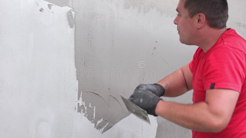Young Man Worker Application of Glue or Adhesive on the Facade of the ...