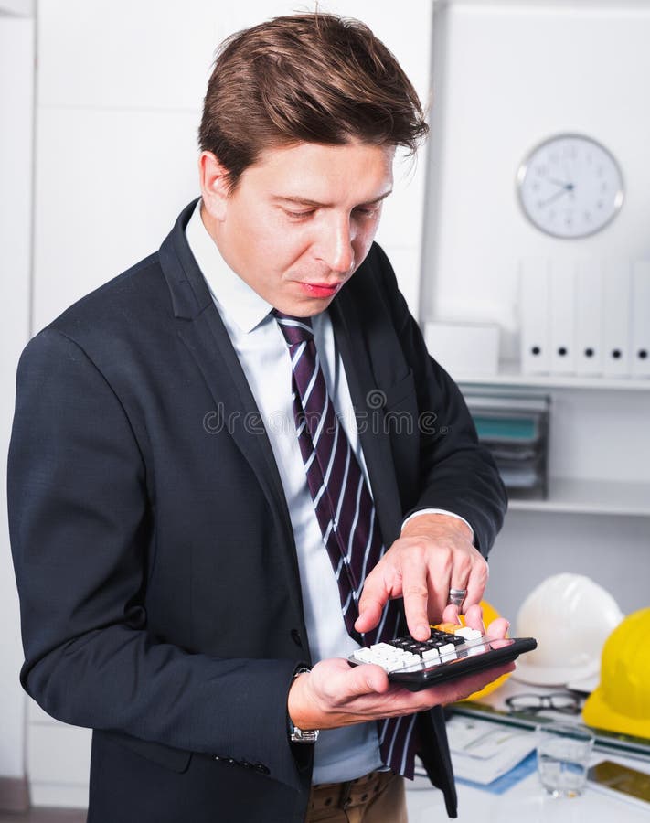 Young Man Worker Calculating in the Office on the Computer Stock Image ...