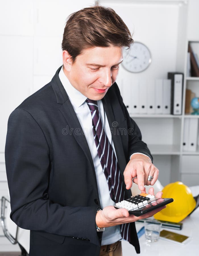 Young Man Worker Calculating in the Office on the Computer Stock Photo ...