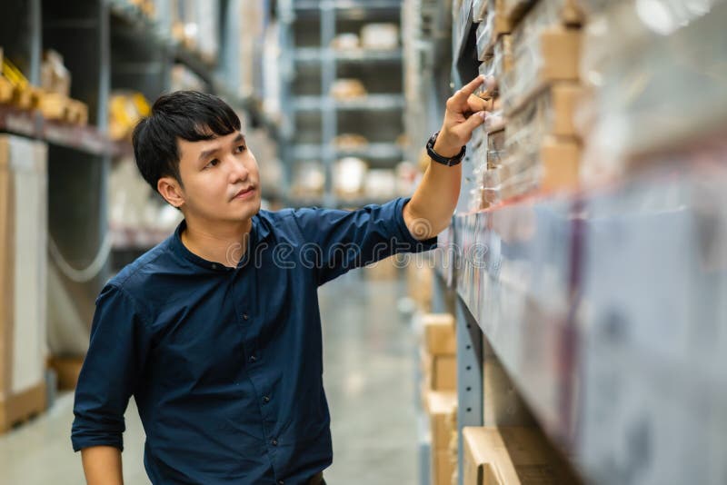 Young Man Worker Checking Inventory in Warehouse Store Stock Photo ...