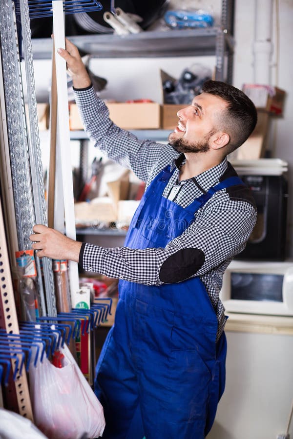 Young Man Worker Examining Plastic Corners for Tiles and Floors Stock ...