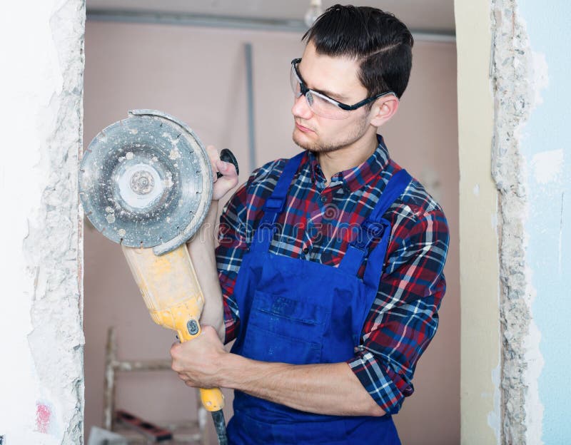 Young Man Worker Using Professional Angle Grinder Stock Image - Image ...