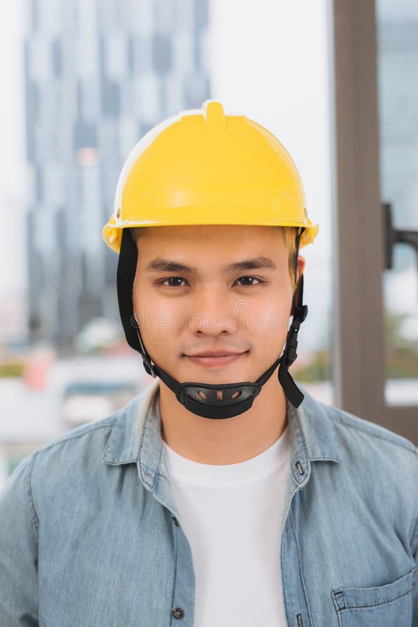 Young Man Worker with a Yellow Helmet on the Construction Site Stock ...