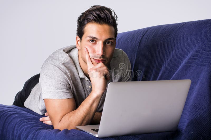 Young Man Working with Computer on Couch Stock Photo - Image of people ...