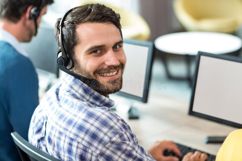 Young Man Working on Computer with Headset Stock Photo - Image of ...
