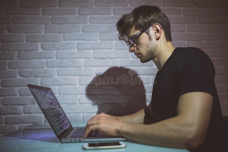Young Man Working on Computer at Night in Dark Office. the Designer ...