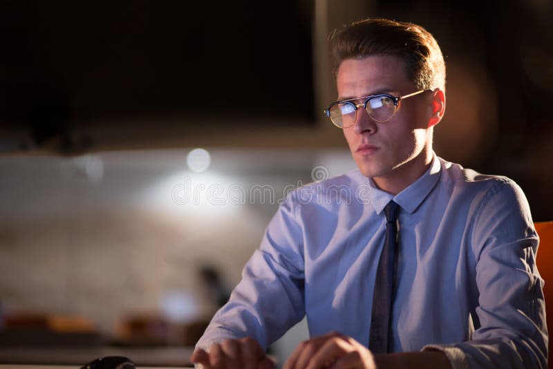 Man Working on Computer in Dark Office Stock Image - Image of desk ...