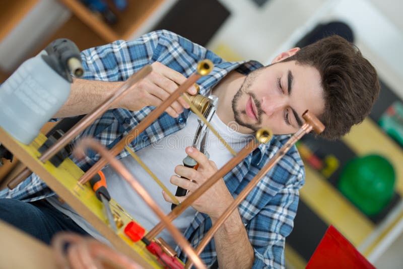 Young Man Working on Copper Pipes Stock Photo - Image of copper, worker ...