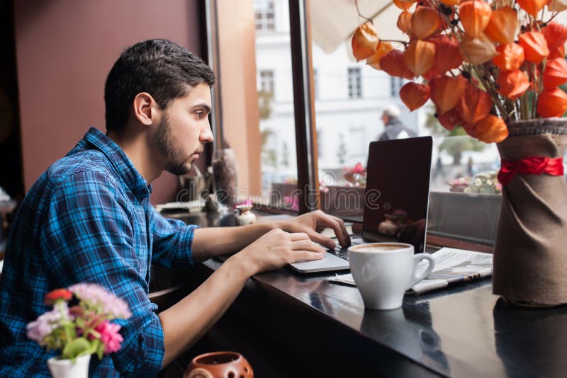 Young Man Working on His Computer at the Cafe Stock Photo - Image of ...