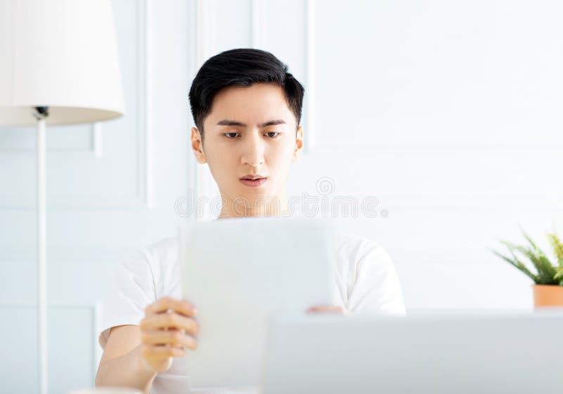 Young Man Working at Home and Reading Data Stock Photo - Image of ...