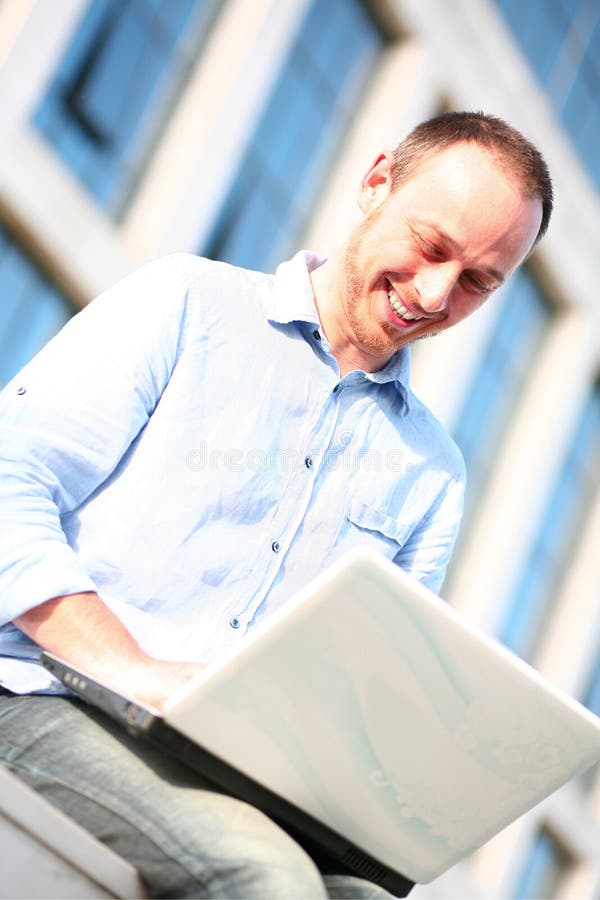 Young Man Working on a Laptop Stock Photo - Image of outdoors, modern ...