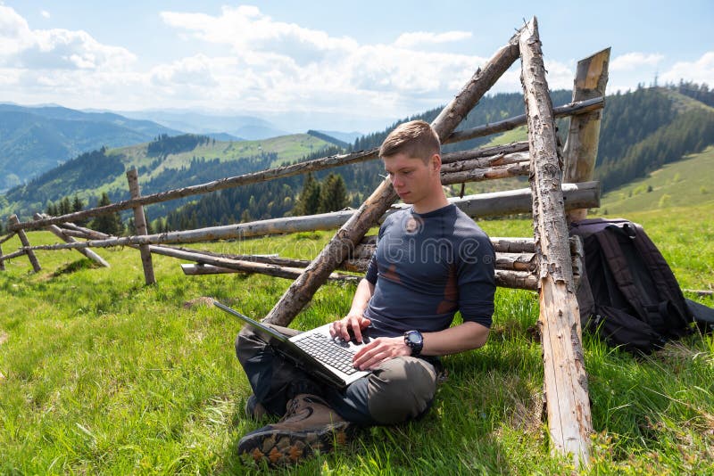 Young Man Working on a Laptop Beech Outdoors Nature Remote Work Stock ...