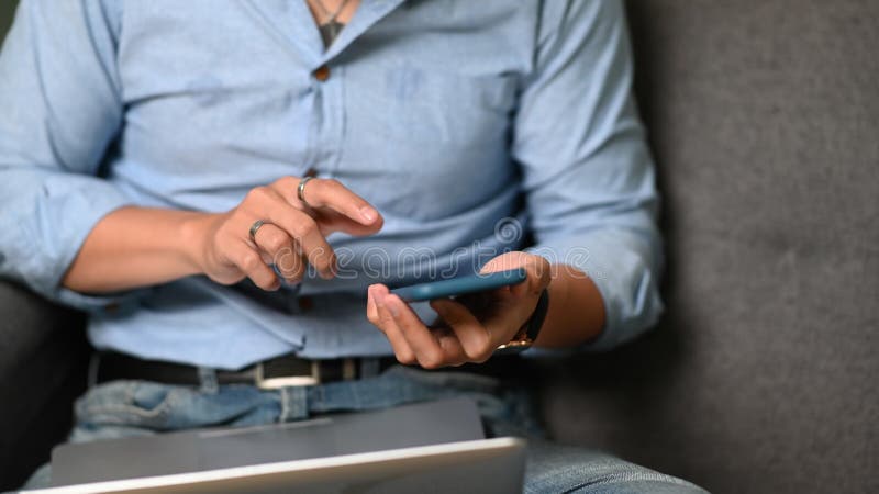 Young Man Working with Laptop Computer and Using Mobile Phone Searching ...
