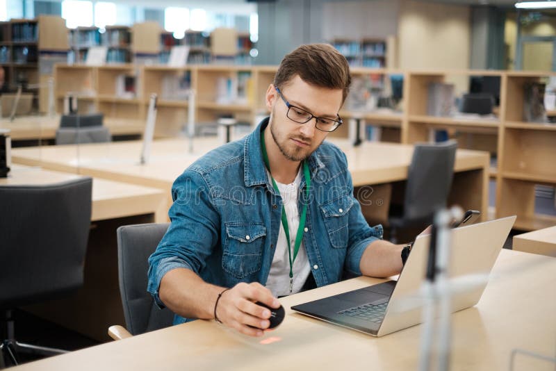 Young Man Working on a Laptop in Public Library Stock Image - Image of ...