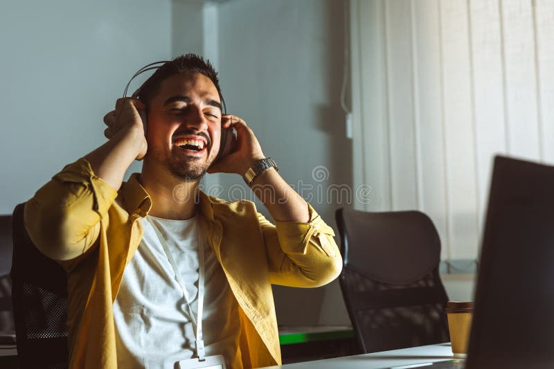 Man Working Late in the Office. a Man is Sitting at a Laptop in a Dark ...