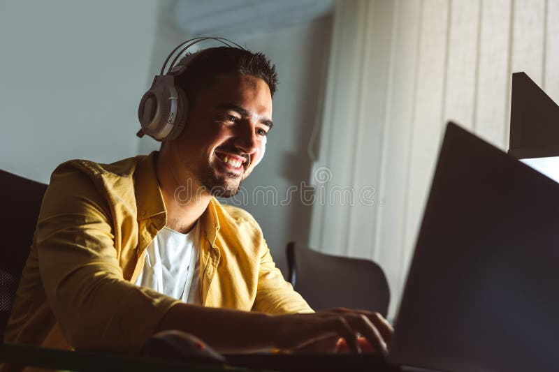 Man Working Late in the Office. a Man is Sitting at a Laptop in a Dark ...