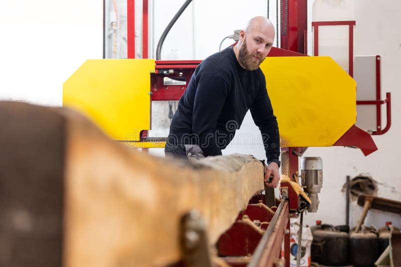 Young Man Working on the Machine for Processing the Wood, Huge Wood ...