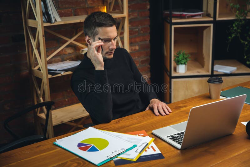 Young Man Working in Modern Office Using Devices and Gadgets. Making ...