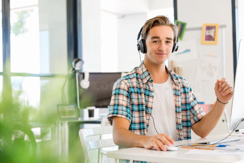 Young Man Working in Office Stock Image - Image of music, positive ...