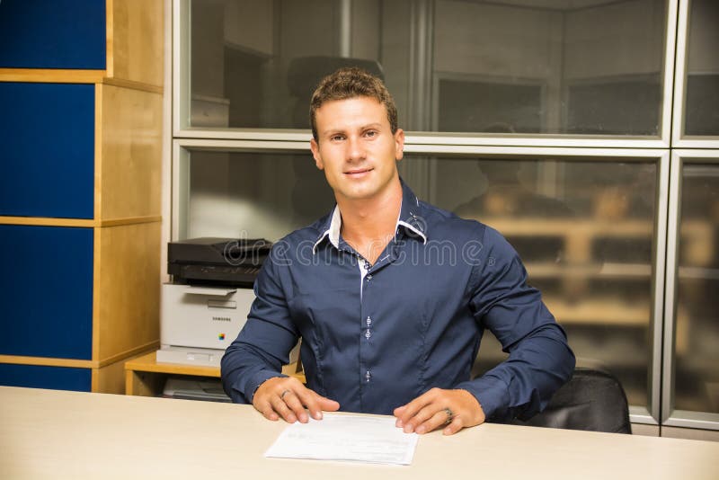 Young Man Working in an Office at the Desk Looking Stock Image - Image ...