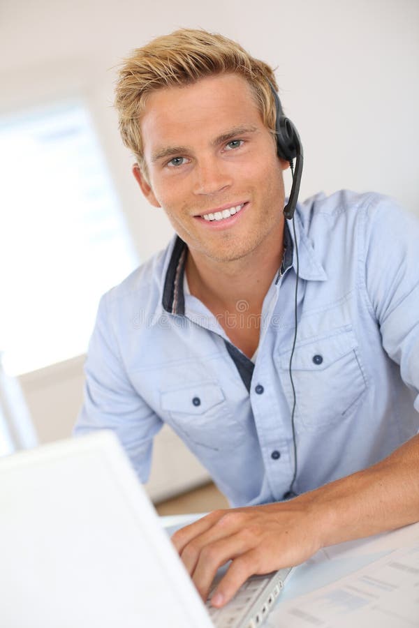 Young Man Working in Office with Headset Stock Photo - Image of ...