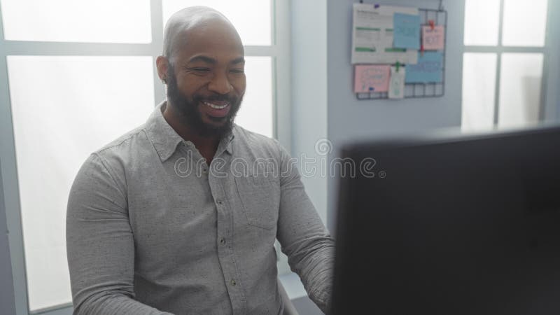 Young Man Working in an Office Setting, Featuring a Bearded, Bald ...