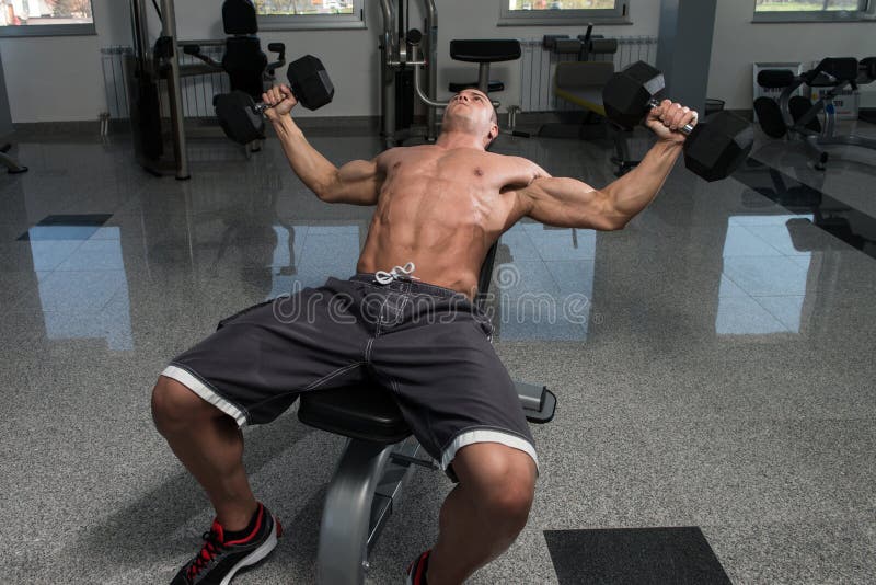 Young Man Working Out Chest with Dumbbells Stock Image - Image of ...