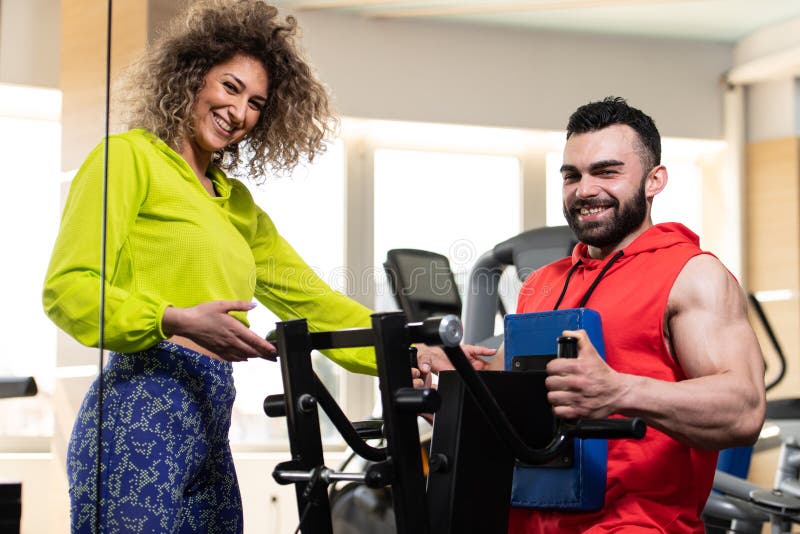 Gym Coach Helping Man on Exercising Back Stock Image - Image of natural ...
