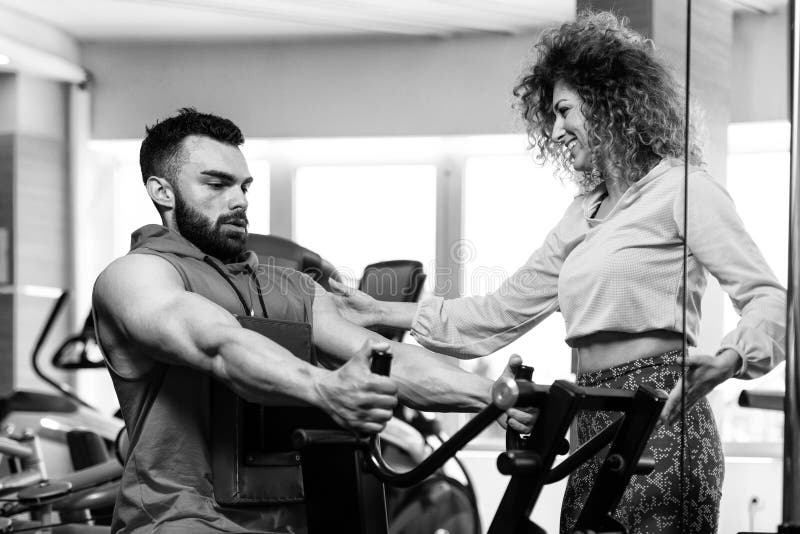 Gym Coach Helping Man on Exercising Back Stock Image - Image of ...