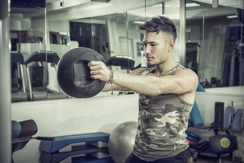 Young Man Working Out in Gym with Kettlebells Stock Image - Image of ...