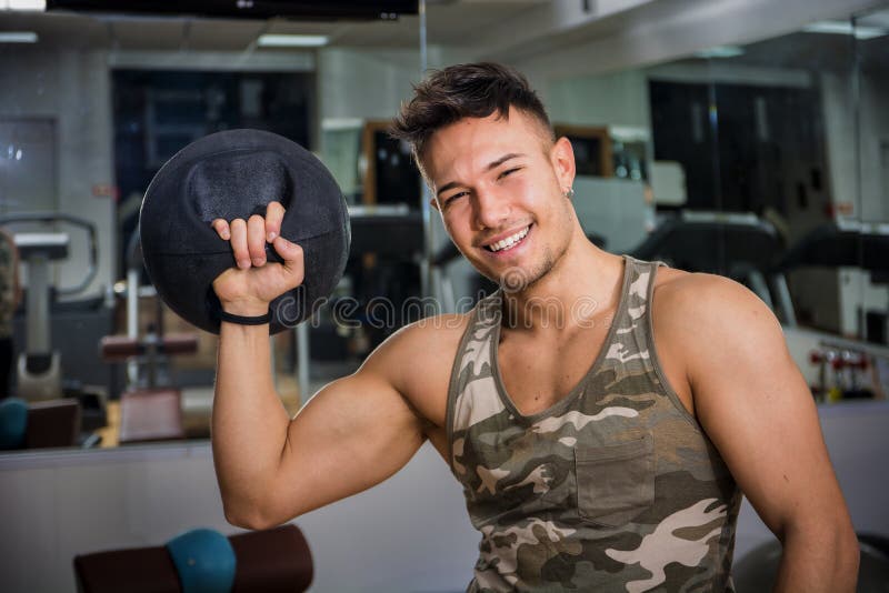 Young Man Working Out in Gym with Kettlebells Stock Photo - Image of ...