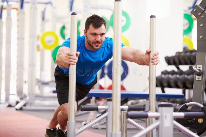 Young Man Working Out Using Equipment at a Gym Stock Image - Image of ...