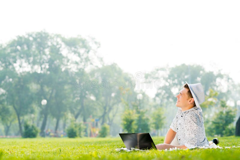 Young Man Working in the Park with a Laptop Stock Image - Image of ...