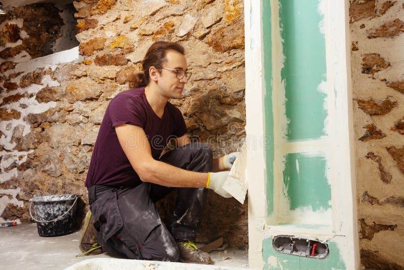 Young Man Working on Plastering Drywall at Home Renovation Stock Image ...