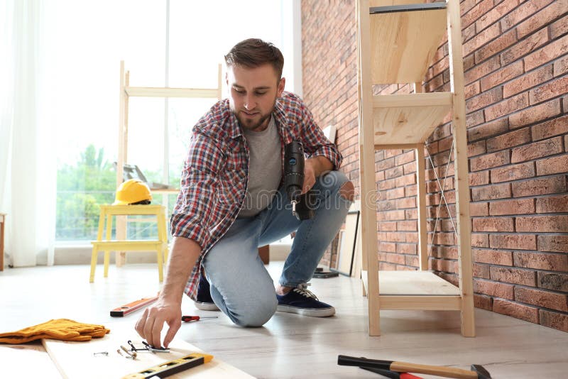 Young Man Working with Shelving Unit Stock Image - Image of fixing ...