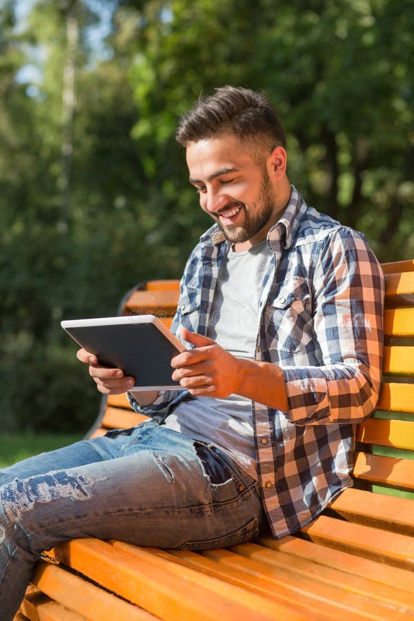Young Man Working on Tablet PC Outdoors Stock Image - Image of single ...