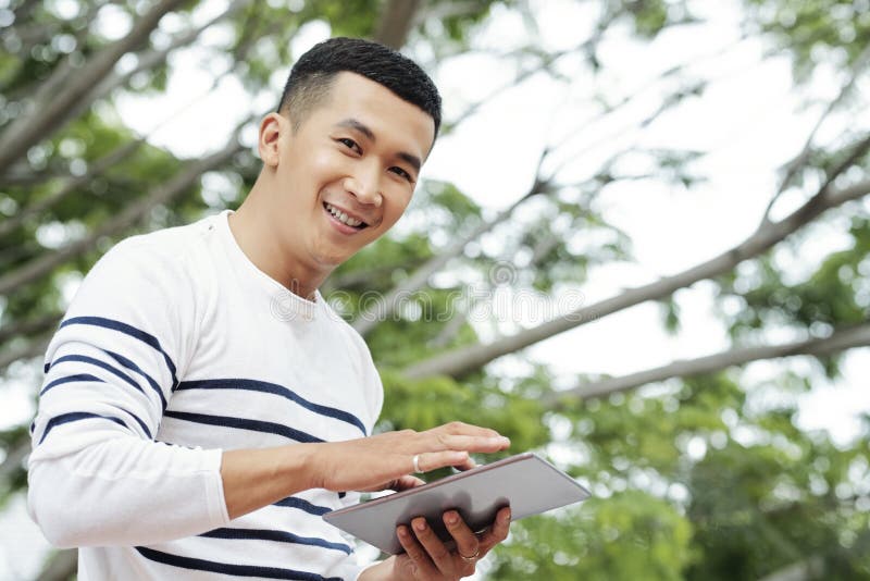 Young Man Working on Tablet Stock Photo - Image of tablet, outdoor ...