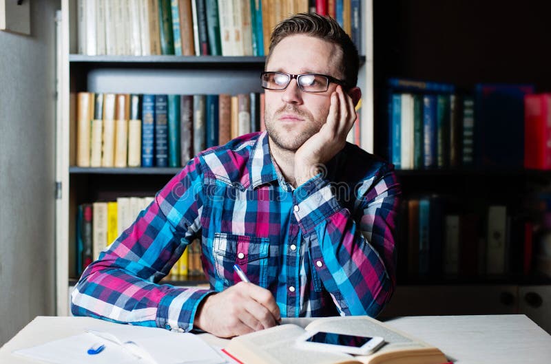 Young Man Working and Thinking in the Library Stock Image - Image of ...